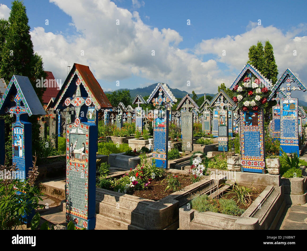 SAPANTA, ROMANIA: Bizarre headstones at the Merry Cemetery shows both ...