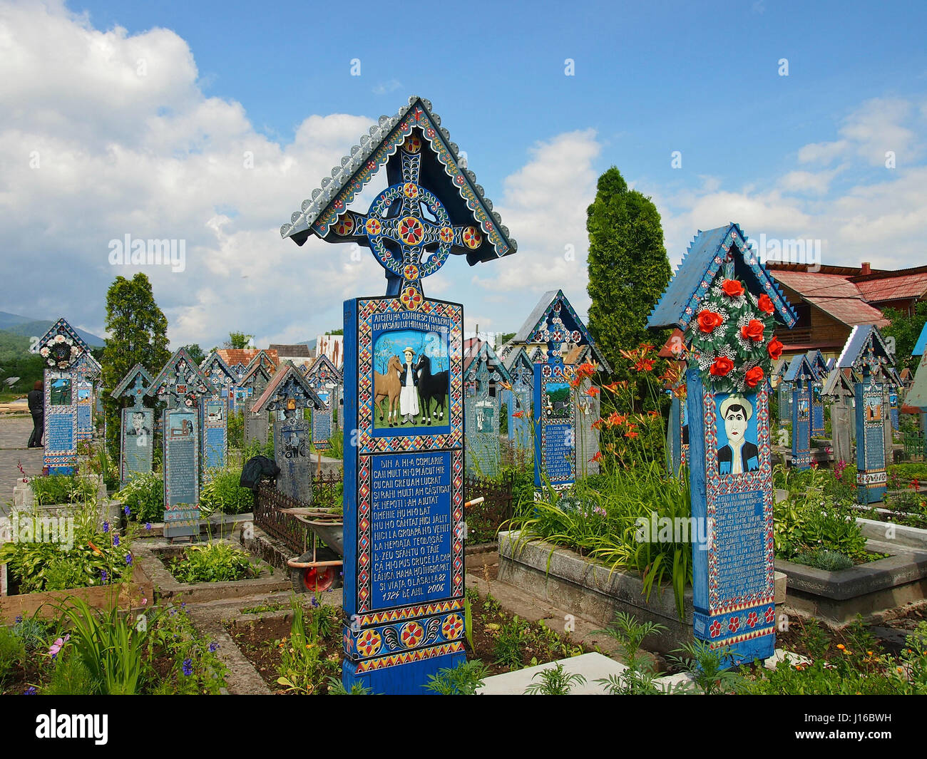 SAPANTA, ROMANIA: Bizarre headstones at the Merry Cemetery shows both ...