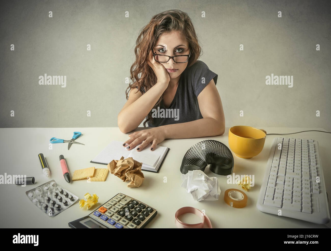 Businesswoman at messy table Stock Photo - Alamy