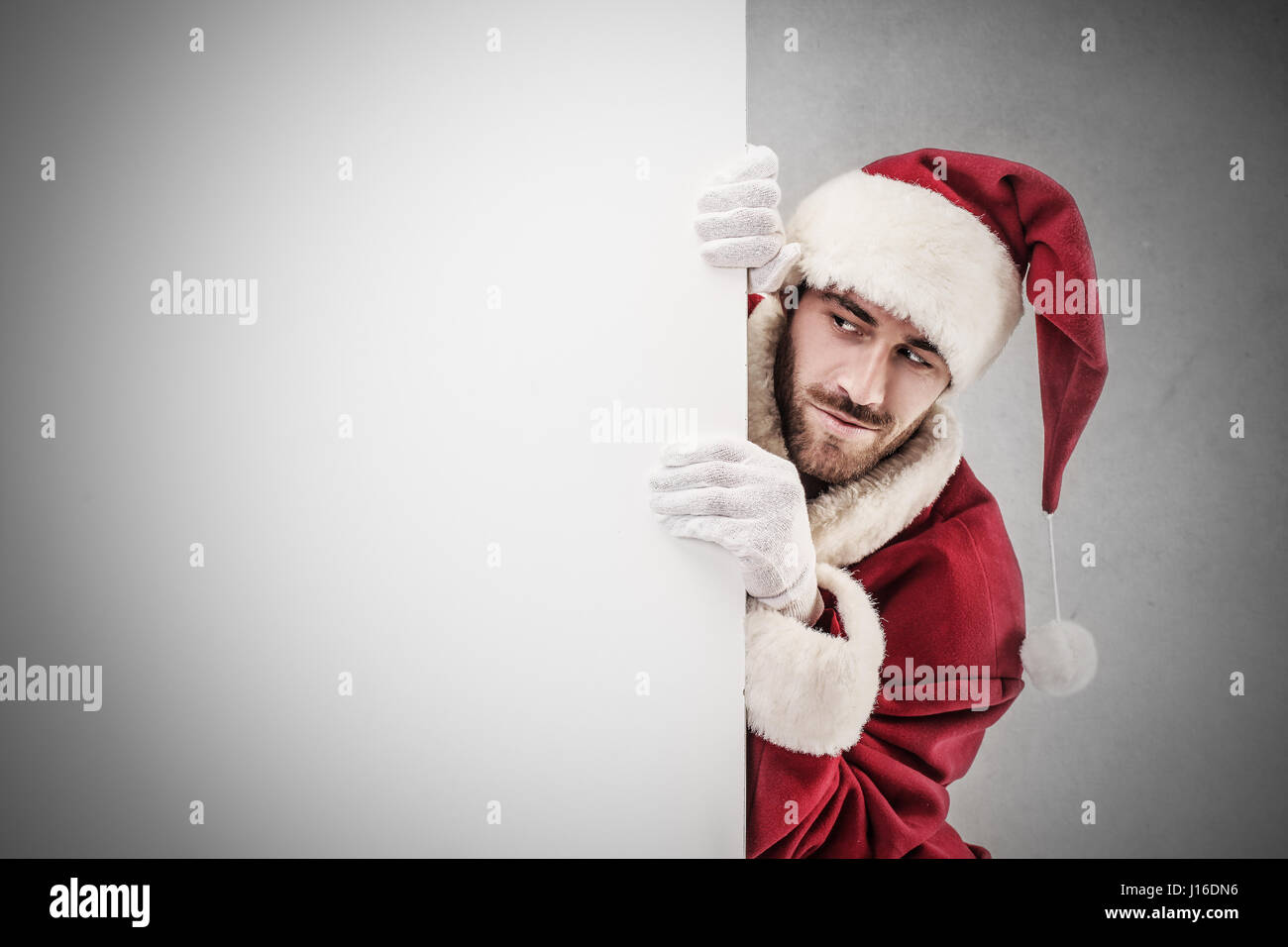 Hiding behind wall hi-res stock photography and images - Alamy