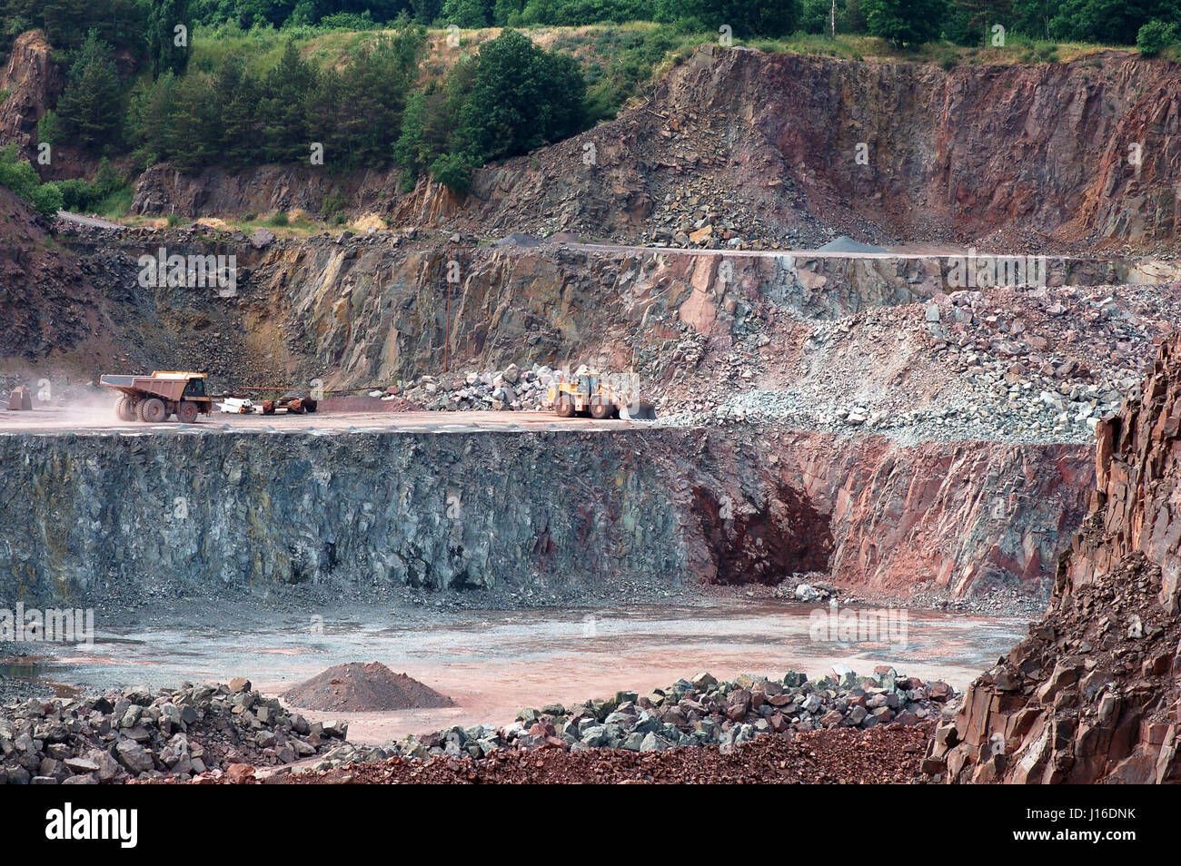 View into a quarry mine with dumper truck and earthmover Stock Photo ...