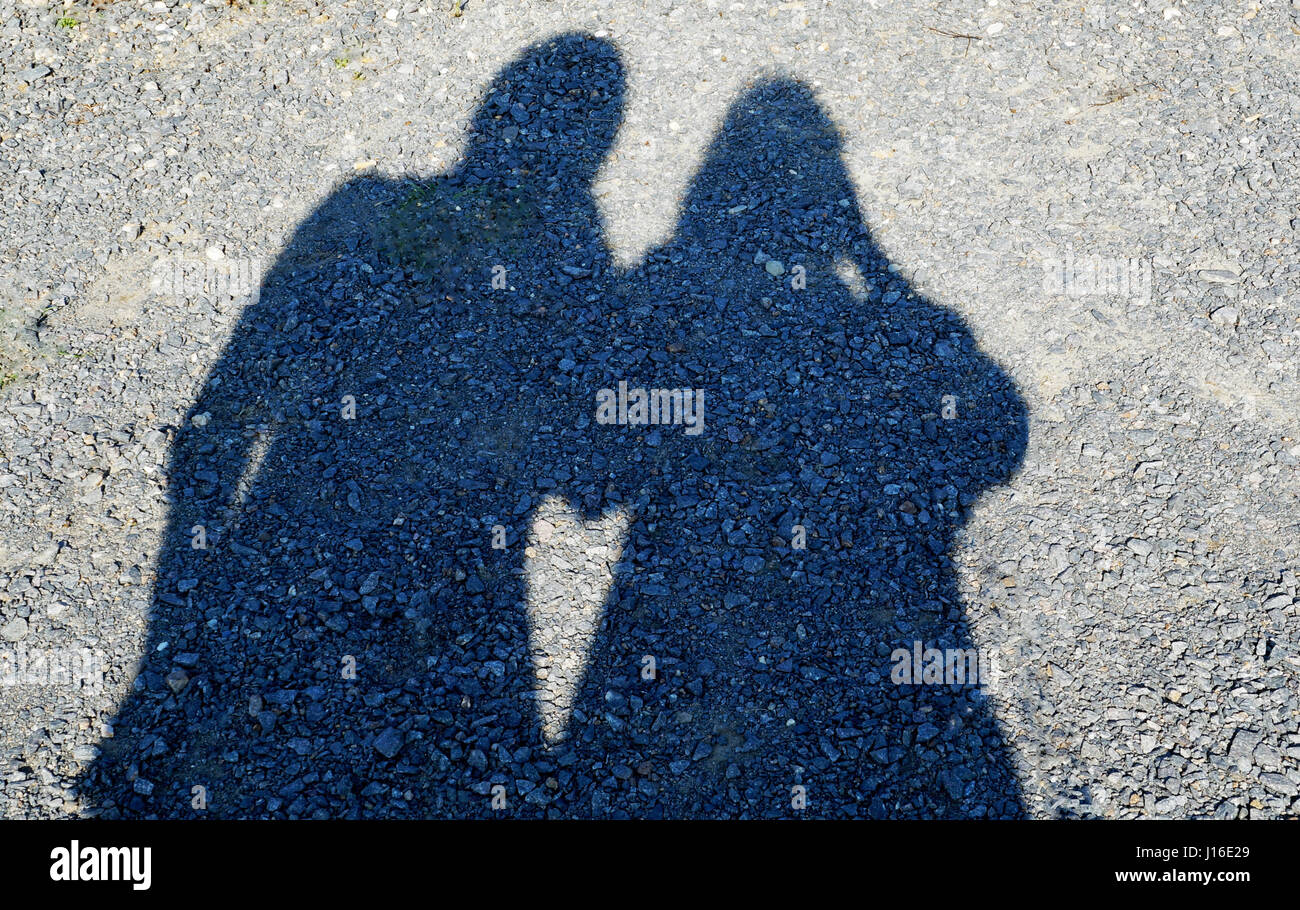 the picture shows a shadow of two people with heart Stock Photo - Alamy