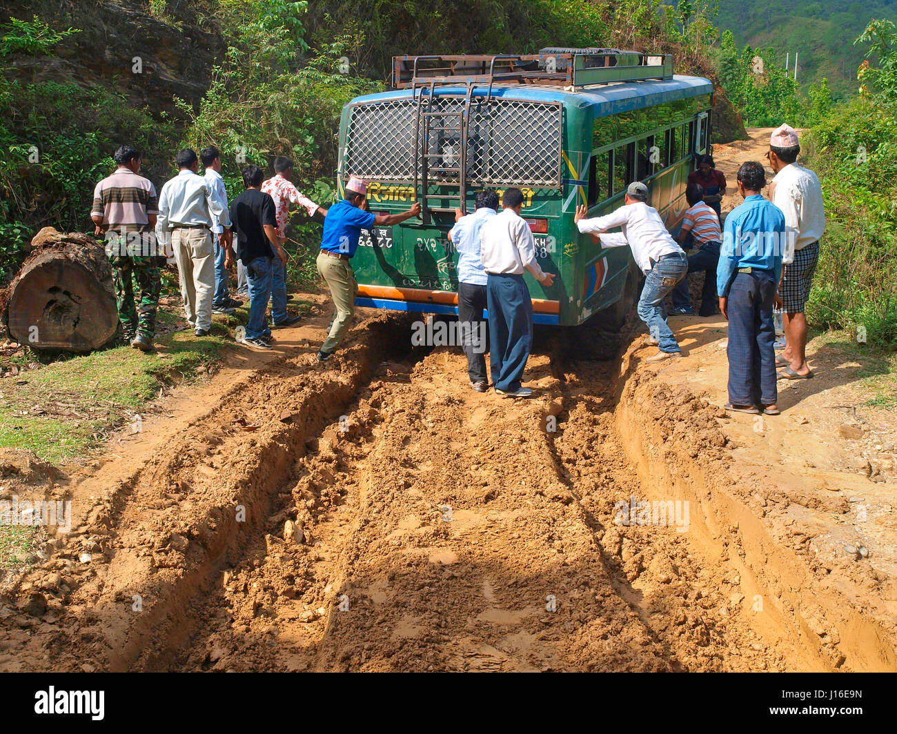 Nepalese People Pushing A Bus That Became Stuck In The Mud, Manaslu ...