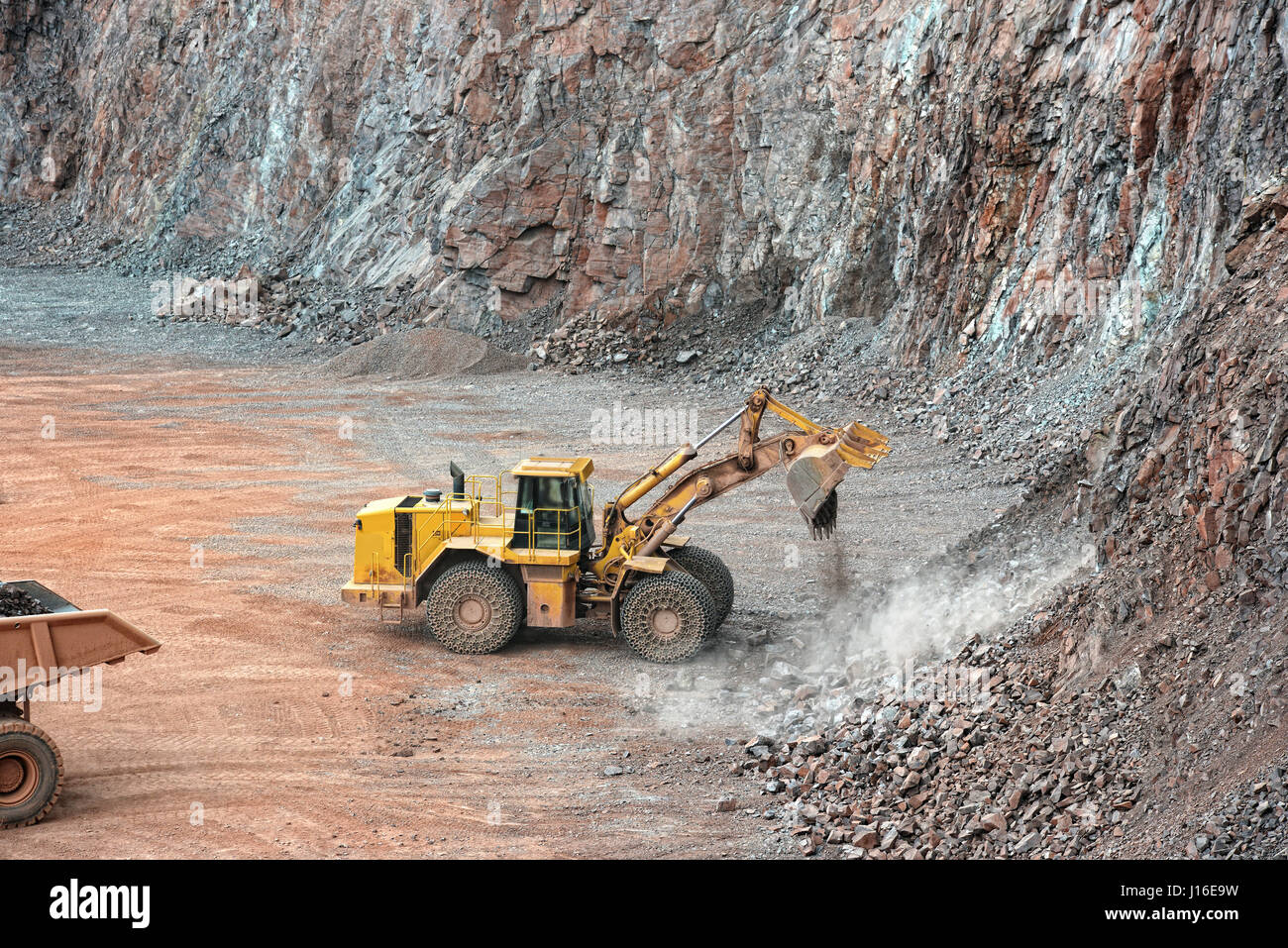 earthmover in a open pit mine quarry. porphyry rock Stock Photo - Alamy