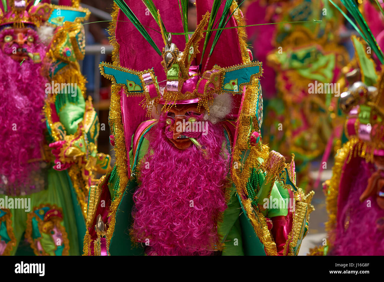 Masked Morenada dancer in ornate costume parading through the mining ...