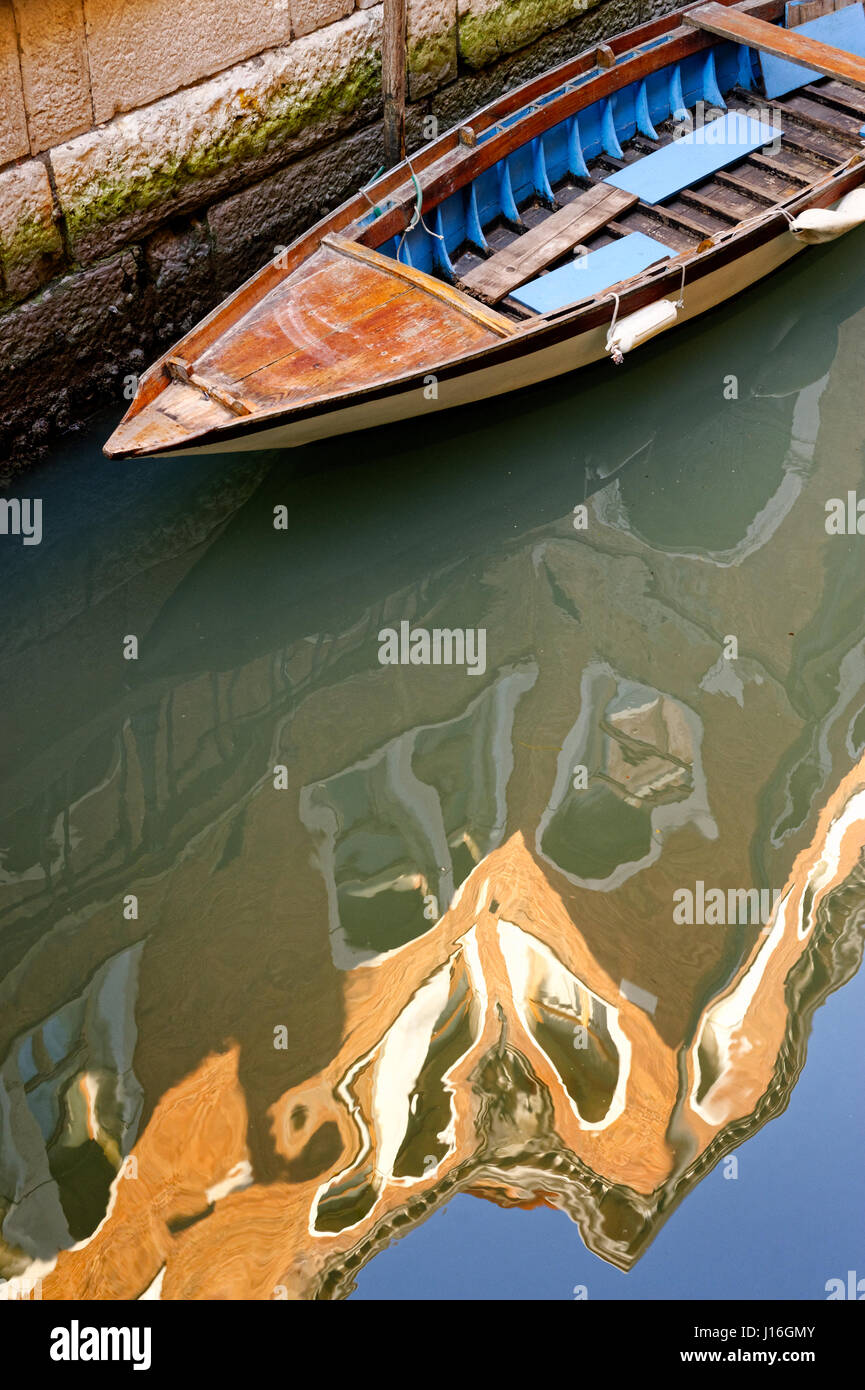 Backgrounds and textures: old boat and old building reflection in water ...