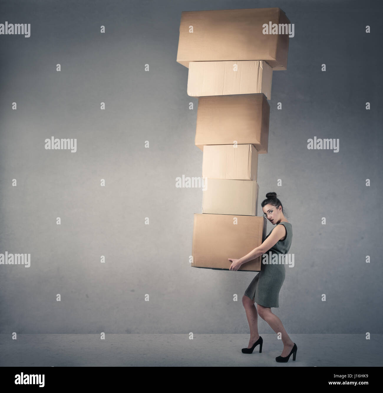 Woman carrying heavy boxes Stock Photo - Alamy