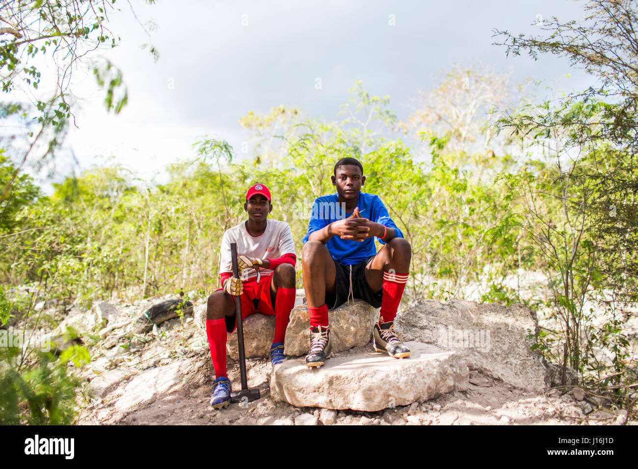 Two Young Man Sit On A Limestone Rock In The Dominican Republic Stock ...