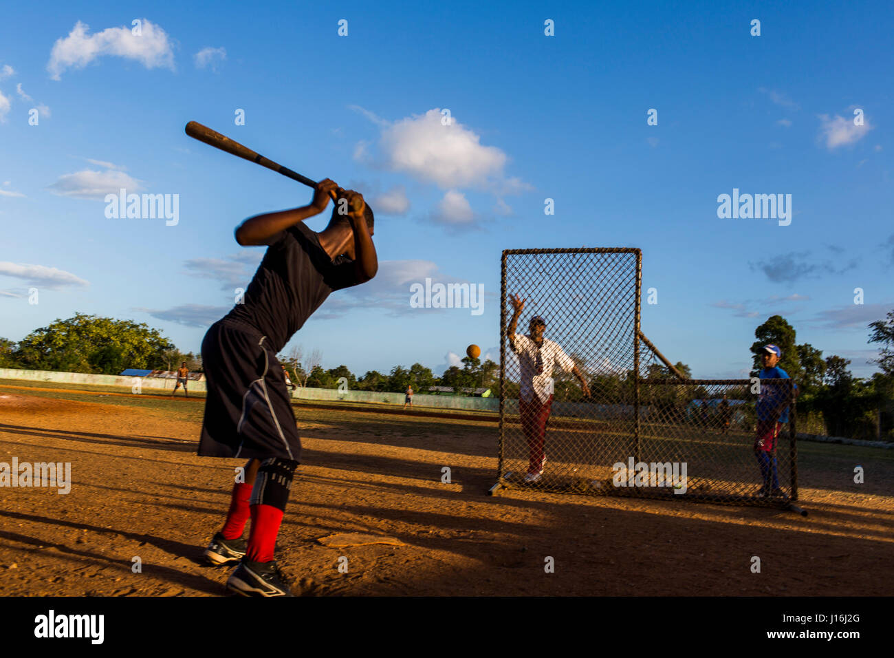 A Young Baseball Player Swinging Bat In The Dominican Republic Stock ...