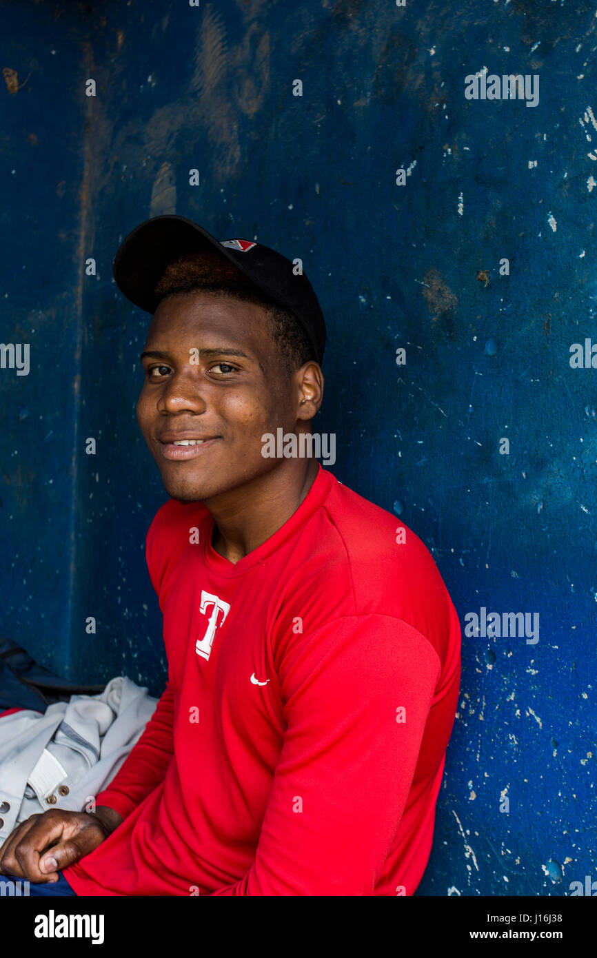 Portrait Of A Baseball Player Against A Dark Blue Dugout Wall In The ...