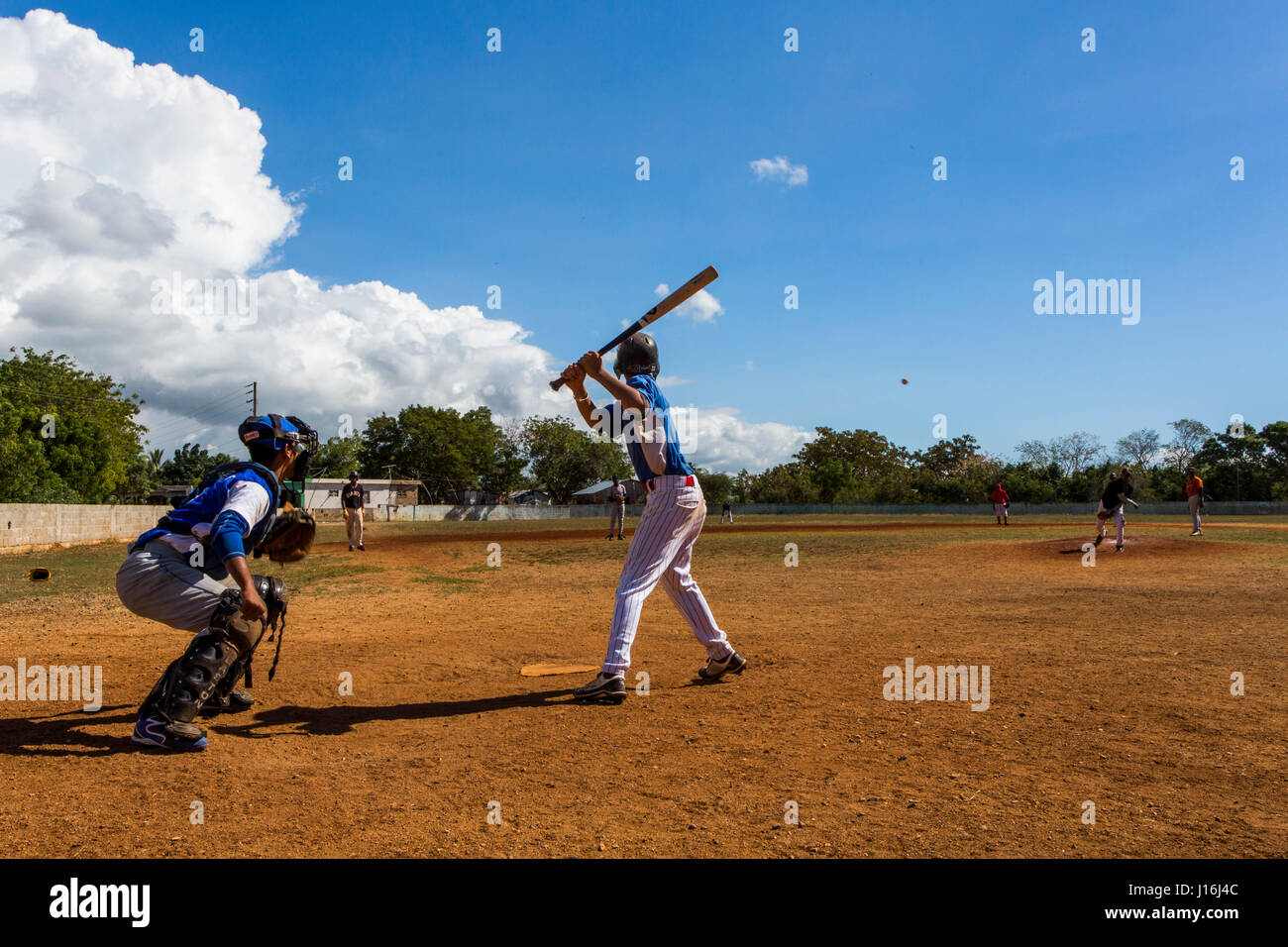 A Baseball Player Swinging Bat At A Pitch In The Dominican Republic ...
