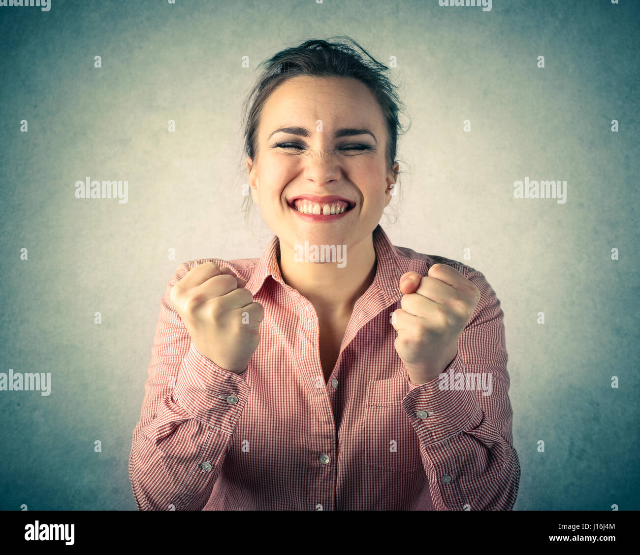 Brunette woman cheering for you Stock Photo - Alamy