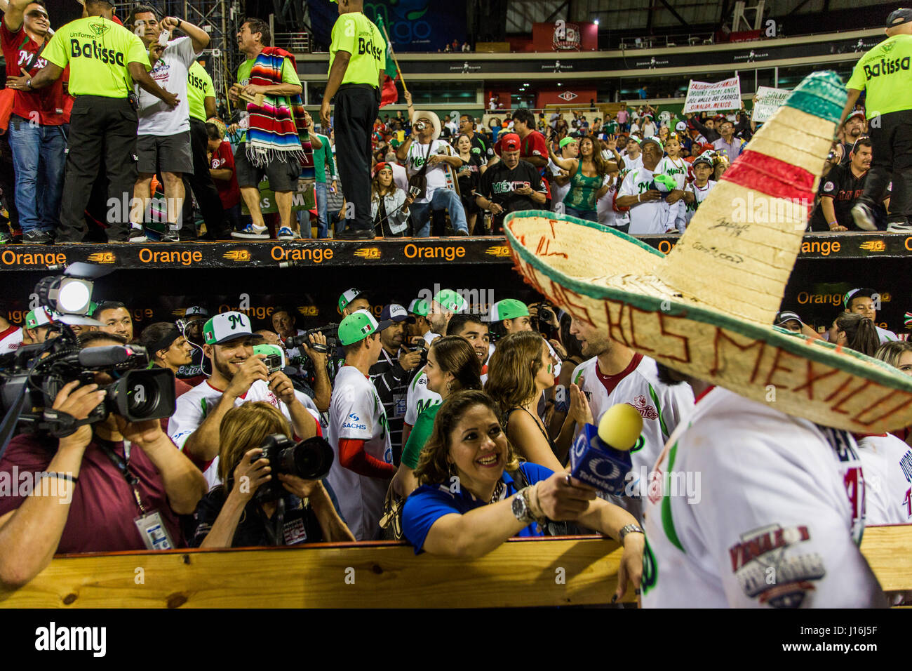 A Professional Baseball Player Wearing A Large Sombrero Hat High-fives ...