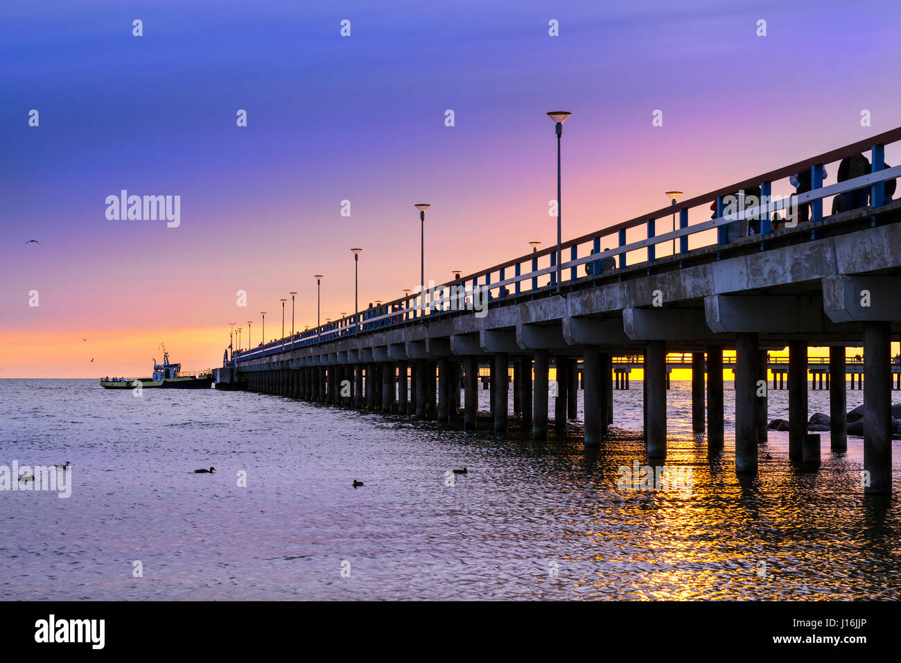 Ferroconcrete pillars of pedestrian seaside pier set in water on coast ...