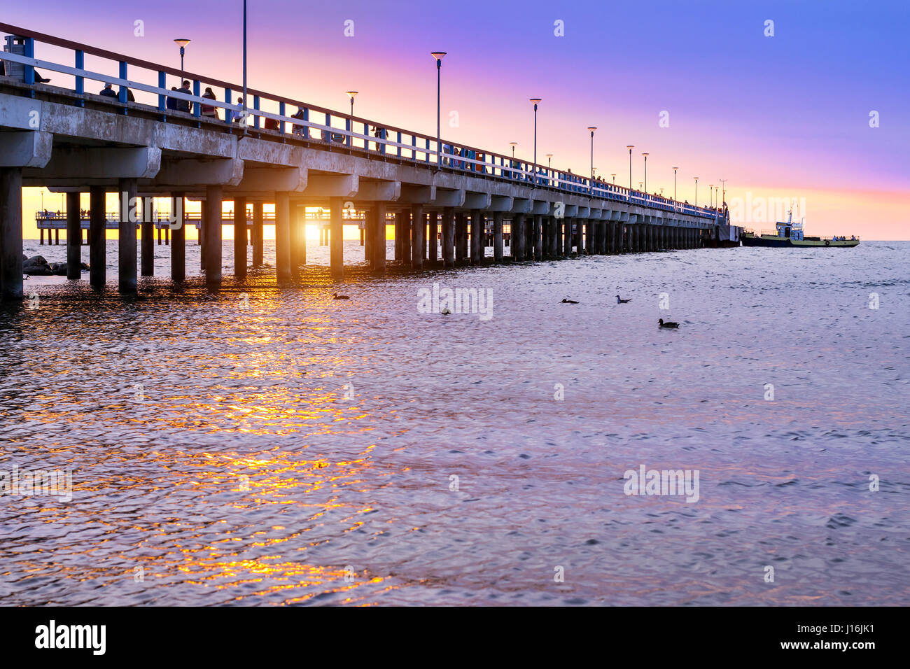Ferroconcrete pillars of pedestrian seaside pier set in water on coast ...
