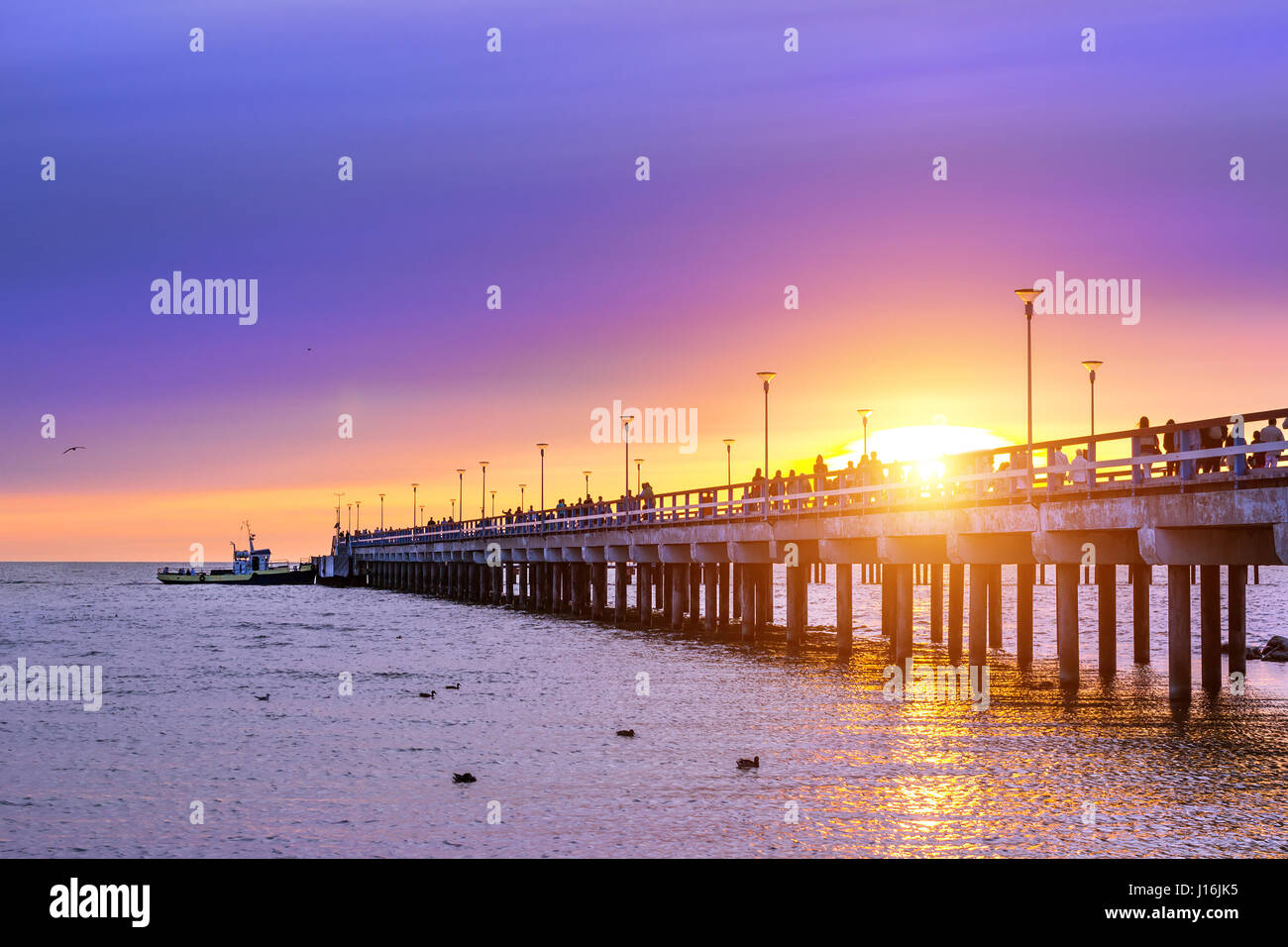 Ferroconcrete pillars of pedestrian seaside pier set in water on coast ...