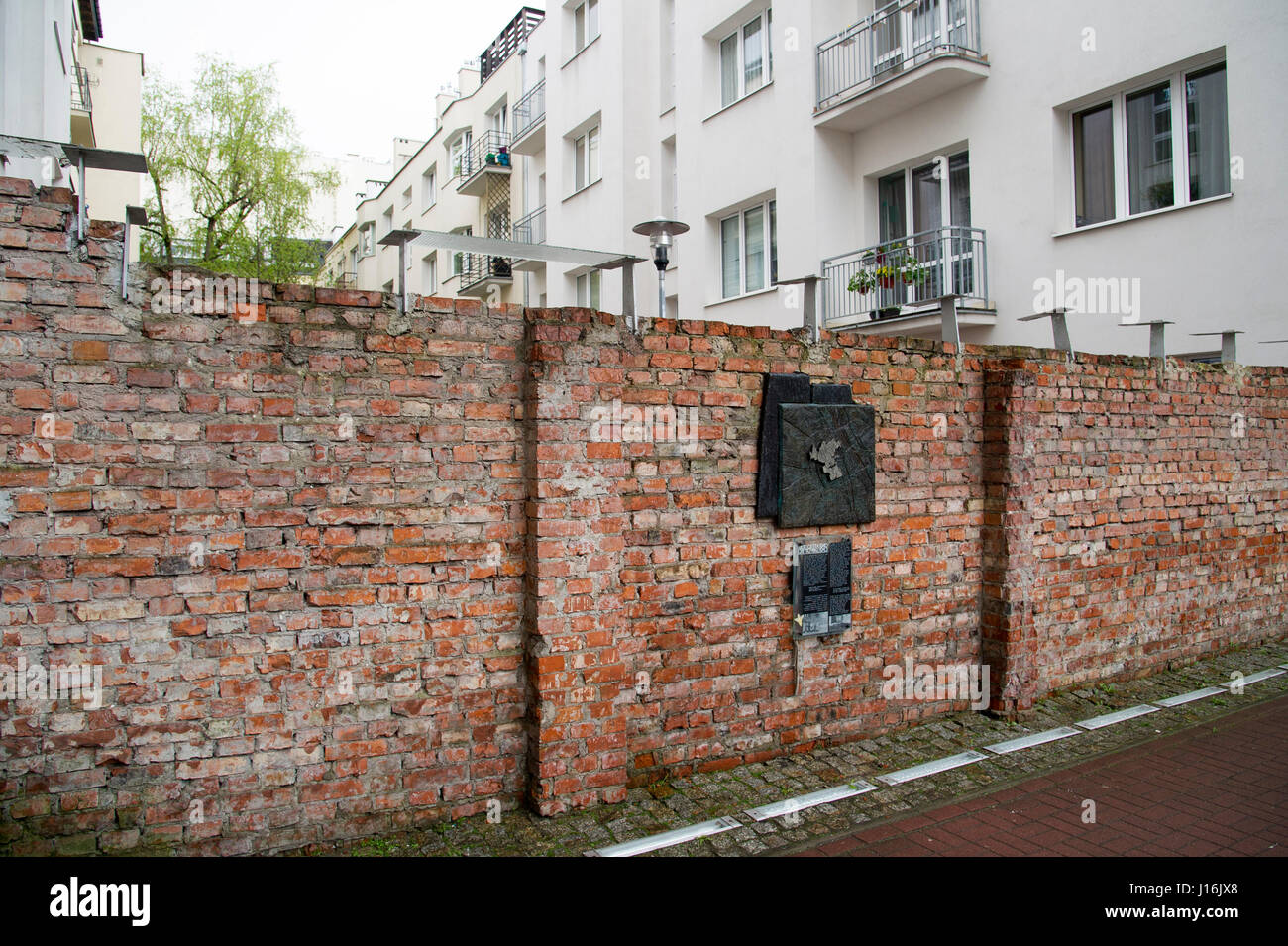 Remnant of the Warsaw Ghetto wall behind a house at 55 Sienna Street in ...