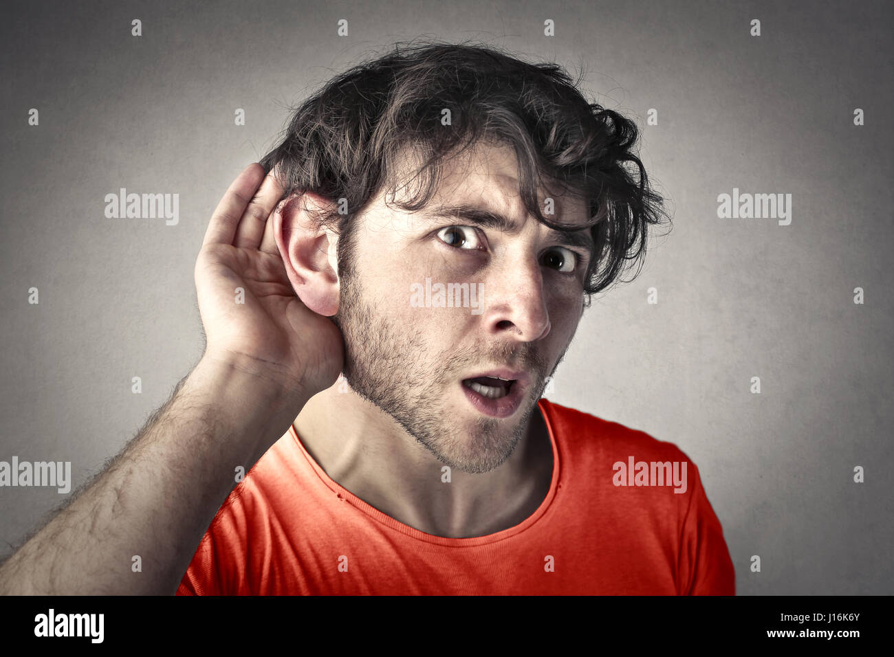 Curious man listening Stock Photo - Alamy