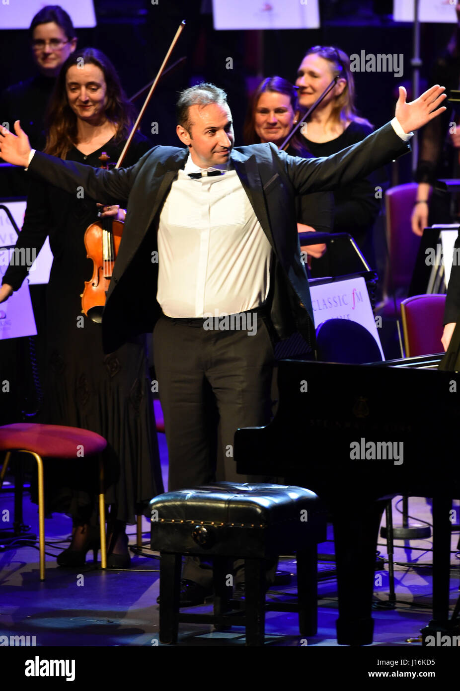 Pianist Simon Trpceski takes a bow after he performs with The ...