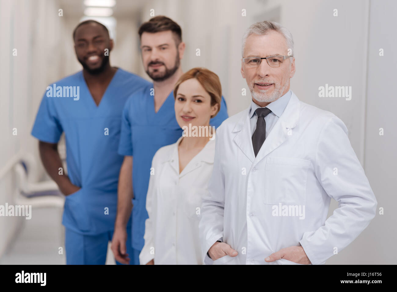 Aged doctor enjoying working hours in the clinic Stock Photo - Alamy