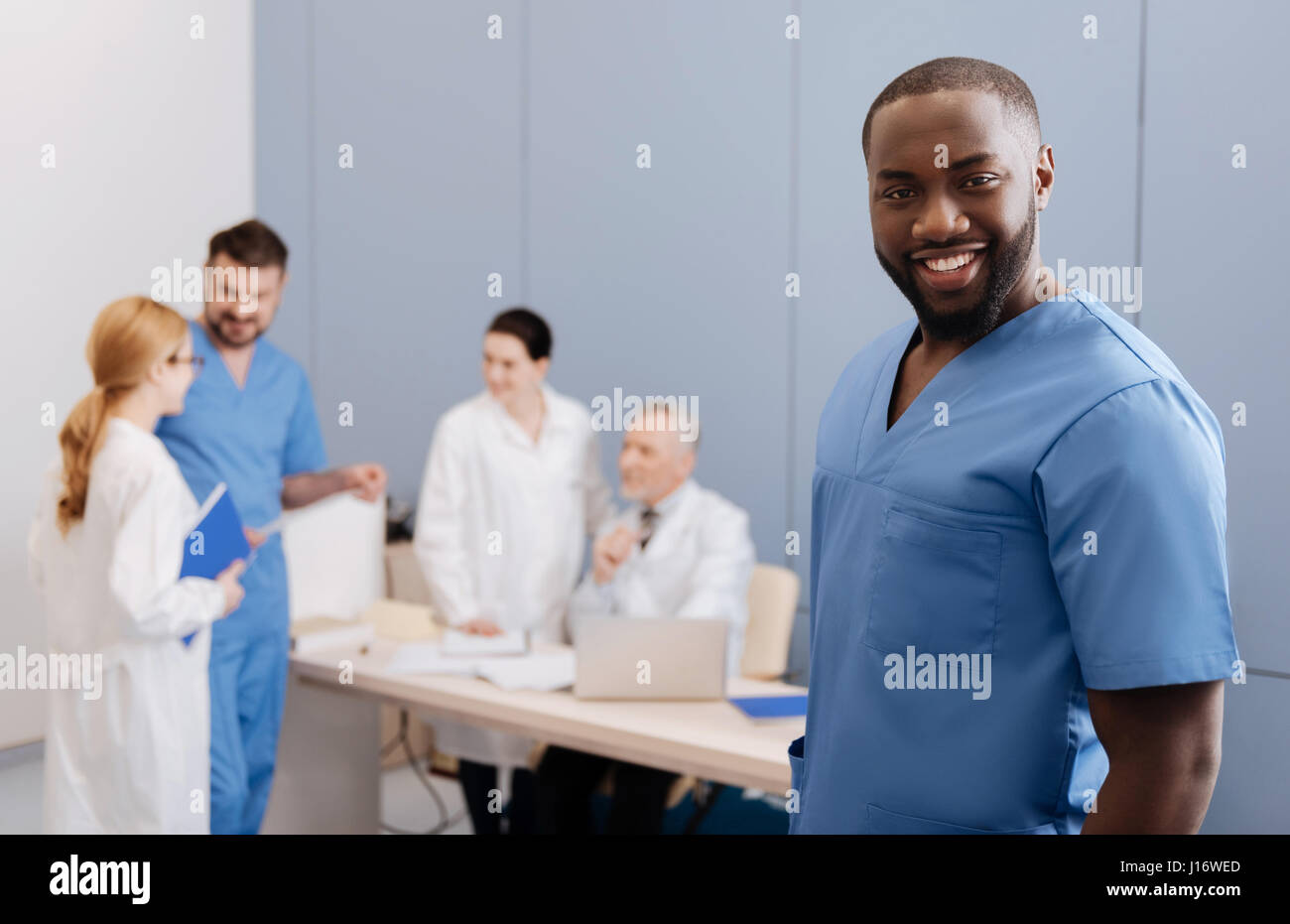 Positive young medic taking part in medical conference at work Stock ...