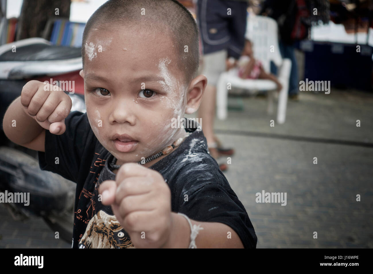 Thailand child posing and adopting a Muay Thai fighting stance ...