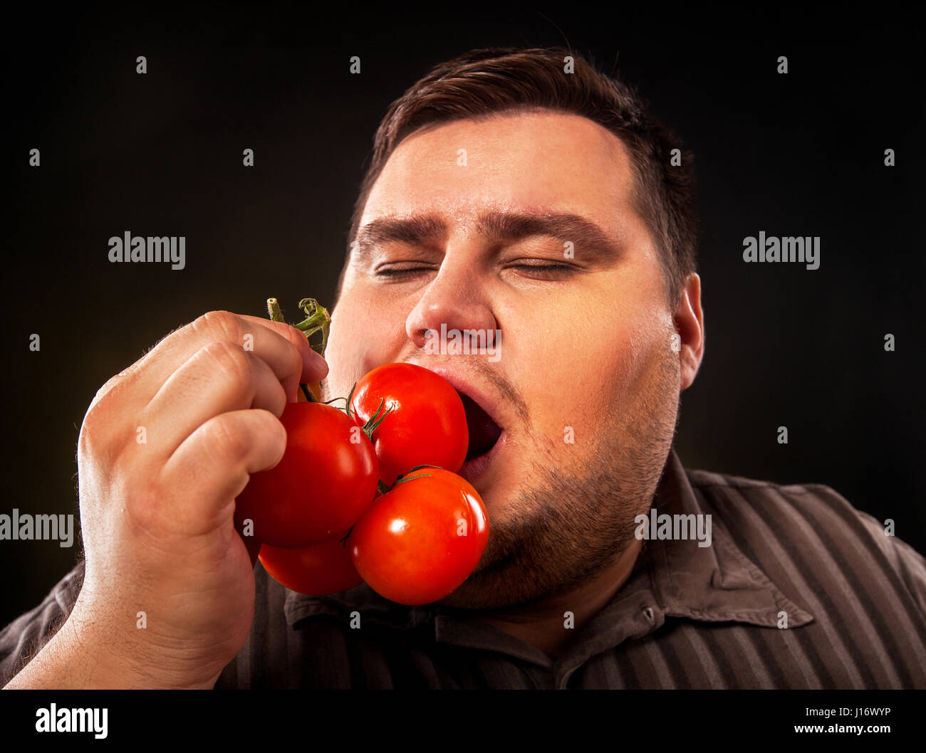Diet fat man eating healthy food . Healthy breakfast with vegetables ...