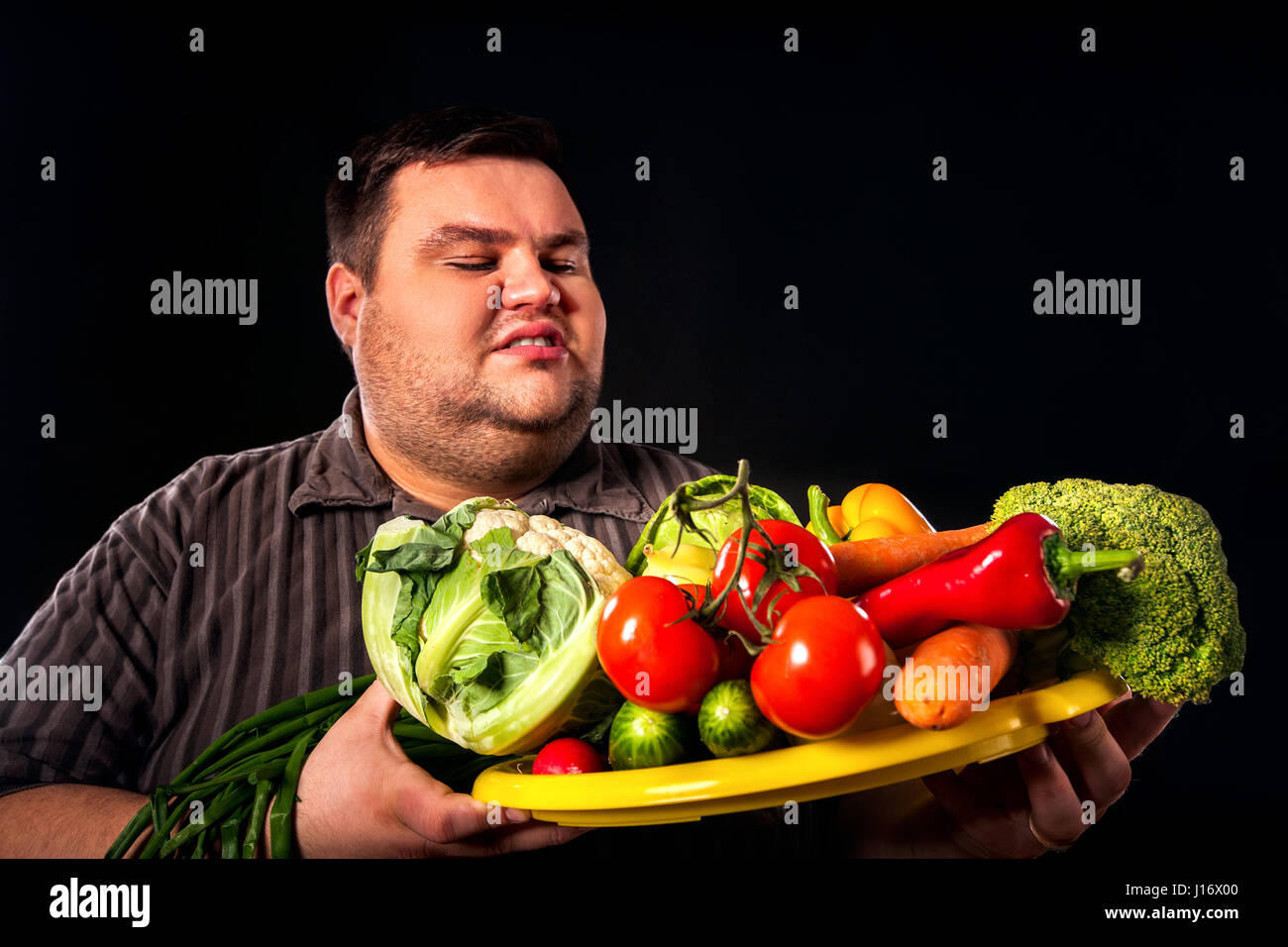 Diet fat man eating healthy food . Healthy breakfast with vegetables ...