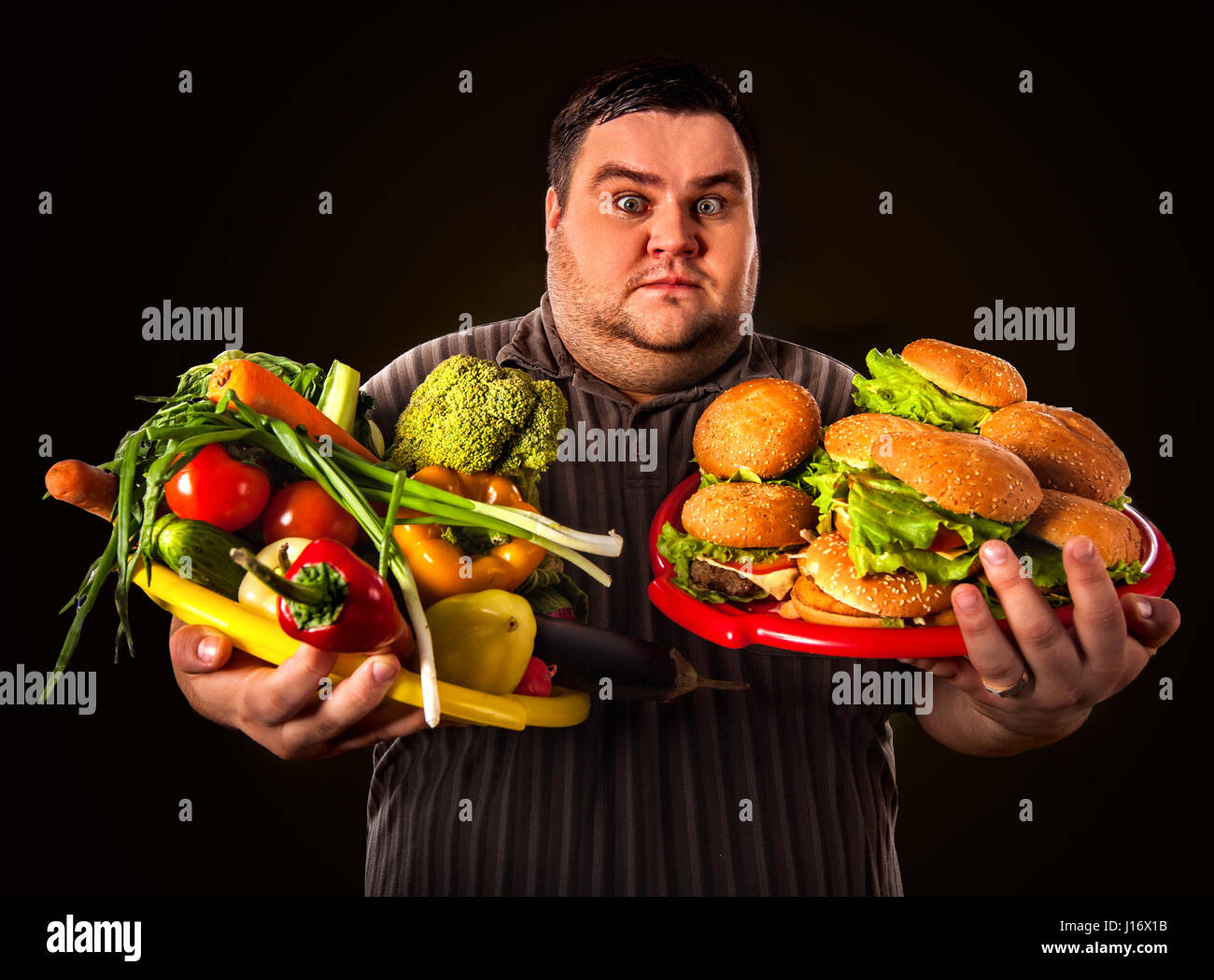 Diet Fat Man Makes Choice Between Healthy And Unhealthy Food Stock diet-fat-man-makes-choice-between-healthy-and-unhealthy-food-stock