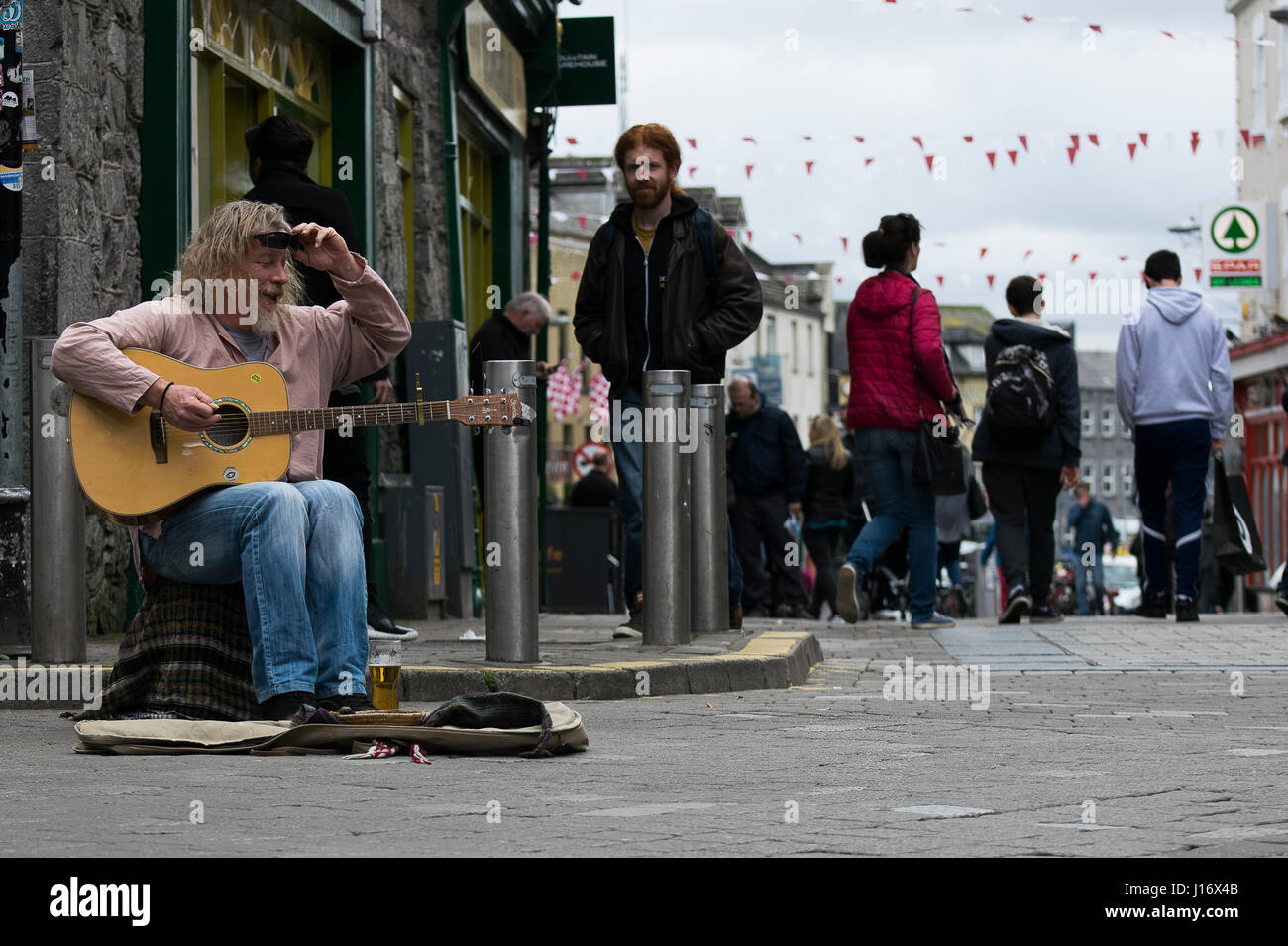 Man Sitting Busking in the Street Stock Photo - Alamy