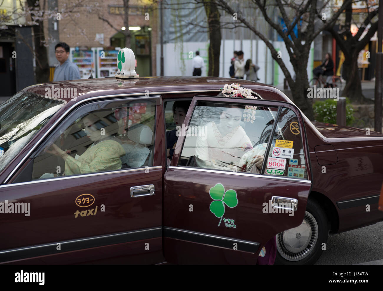 Maiko ( trainee geisha ) getting into taxi on Kiyamachi-dori street in ...
