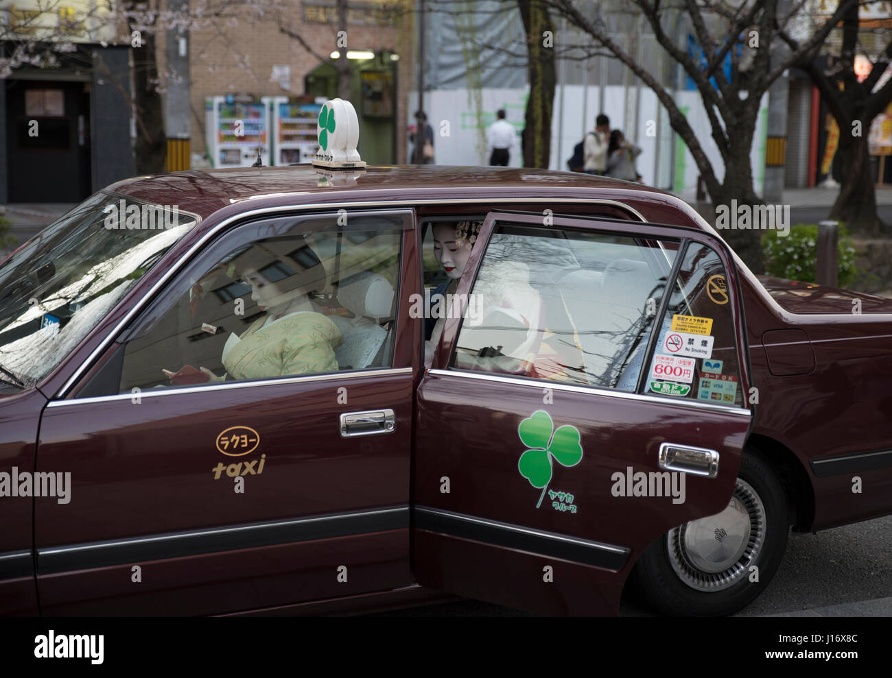 Maiko ( trainee geisha ) getting into taxi on Kiyamachi-dori street in ...