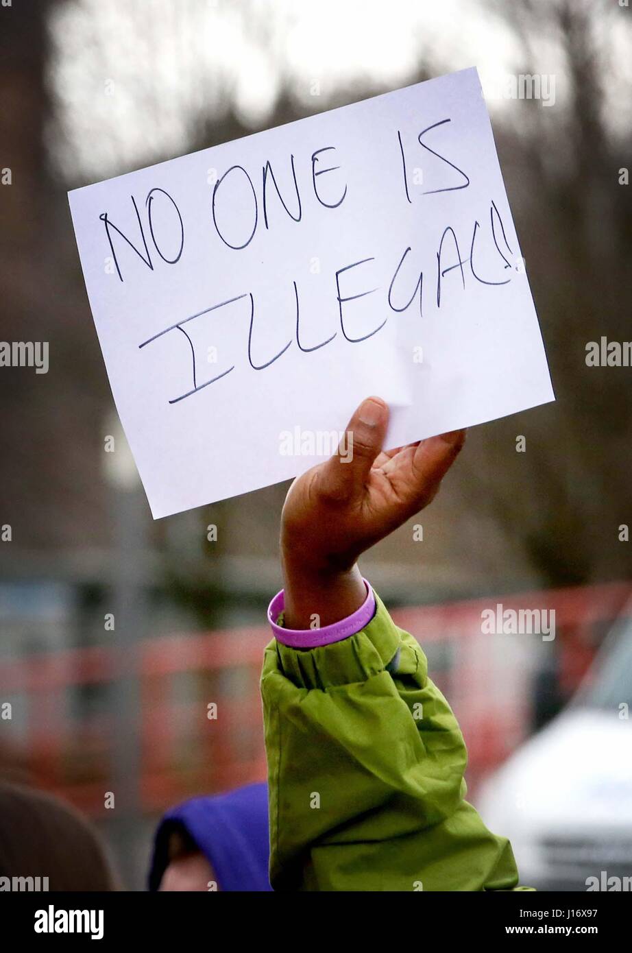 A person holds up a sign reading 'No one is illegal' Stock Photo - Alamy