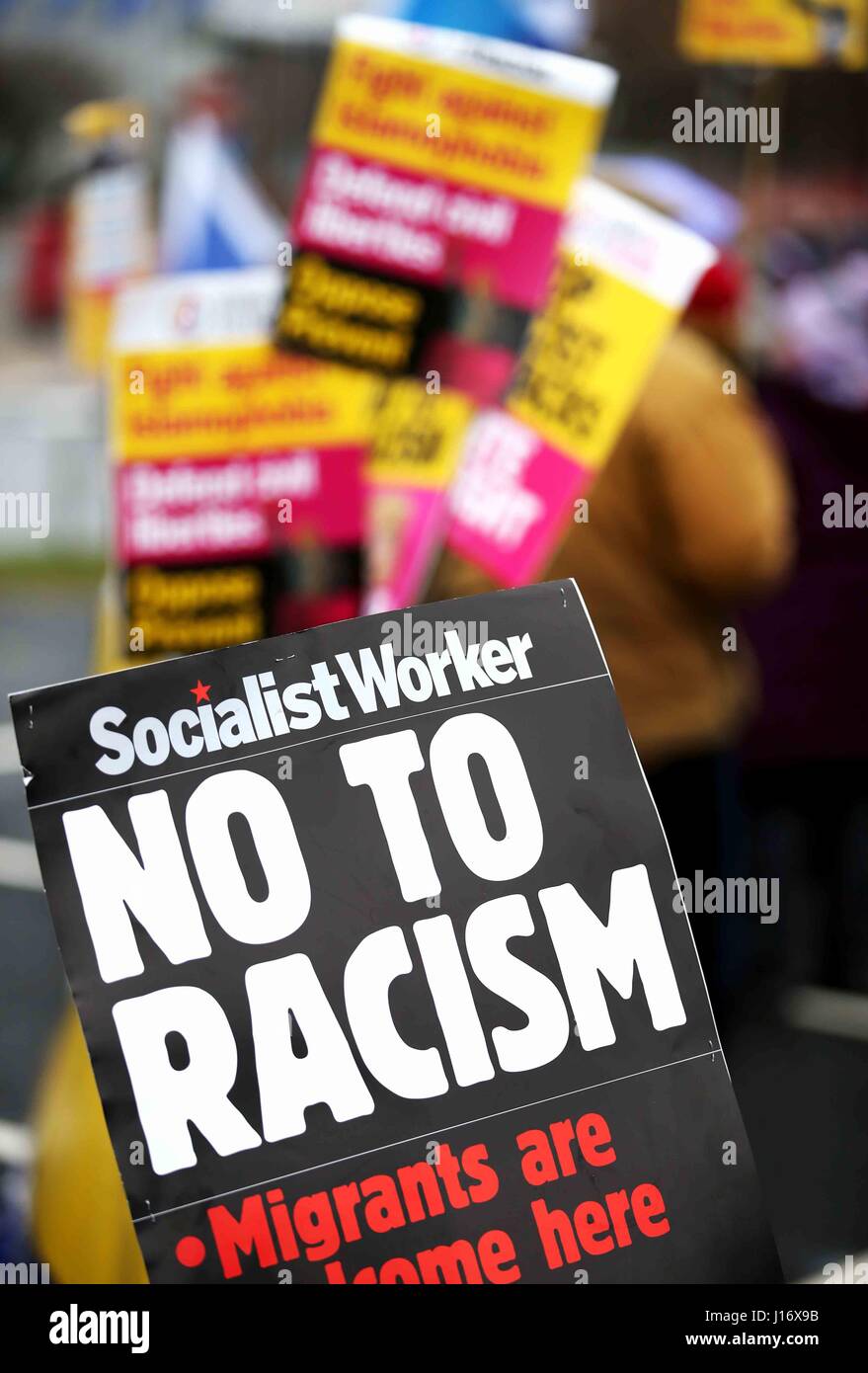 People hold up a signs in protest against racism Stock Photo - Alamy