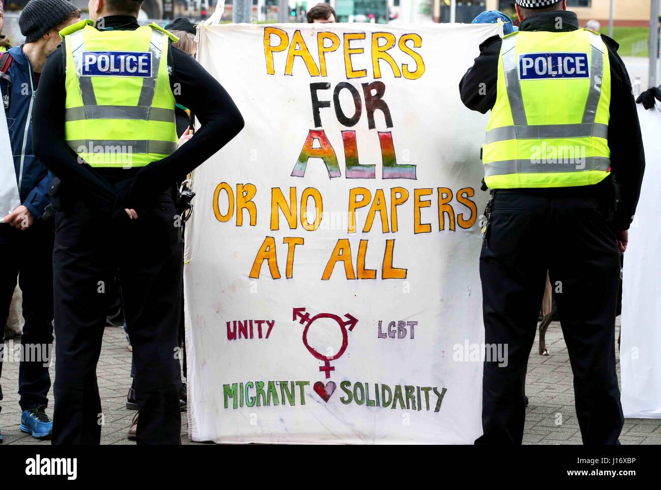 Police officers stand either side of a banner in solidarity with ...
