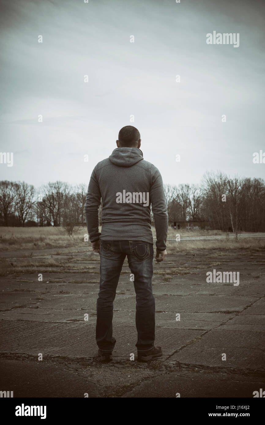 Rear view of a man standing outdoors Stock Photo - Alamy