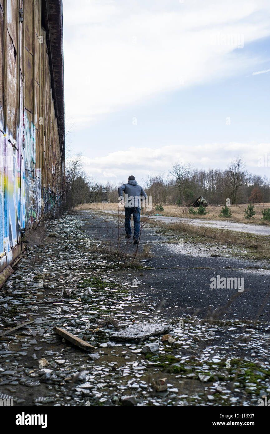Rear view of a man mysterious male running away Stock Photo - Alamy