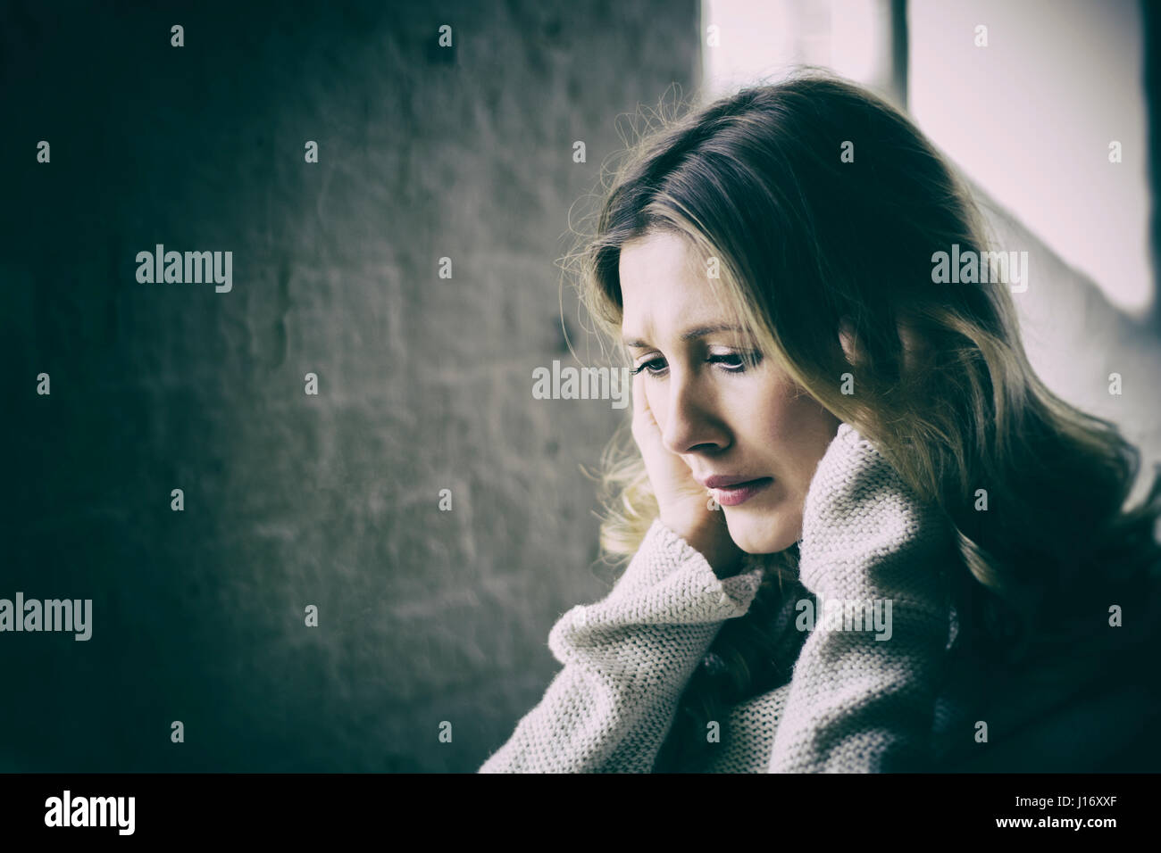 Worried young woman looking away Stock Photo - Alamy