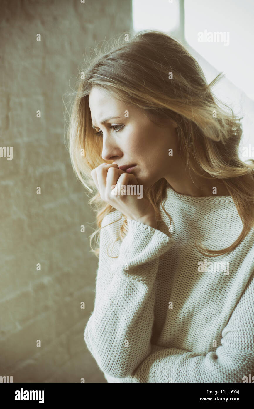 Worried young woman looking away Stock Photo - Alamy