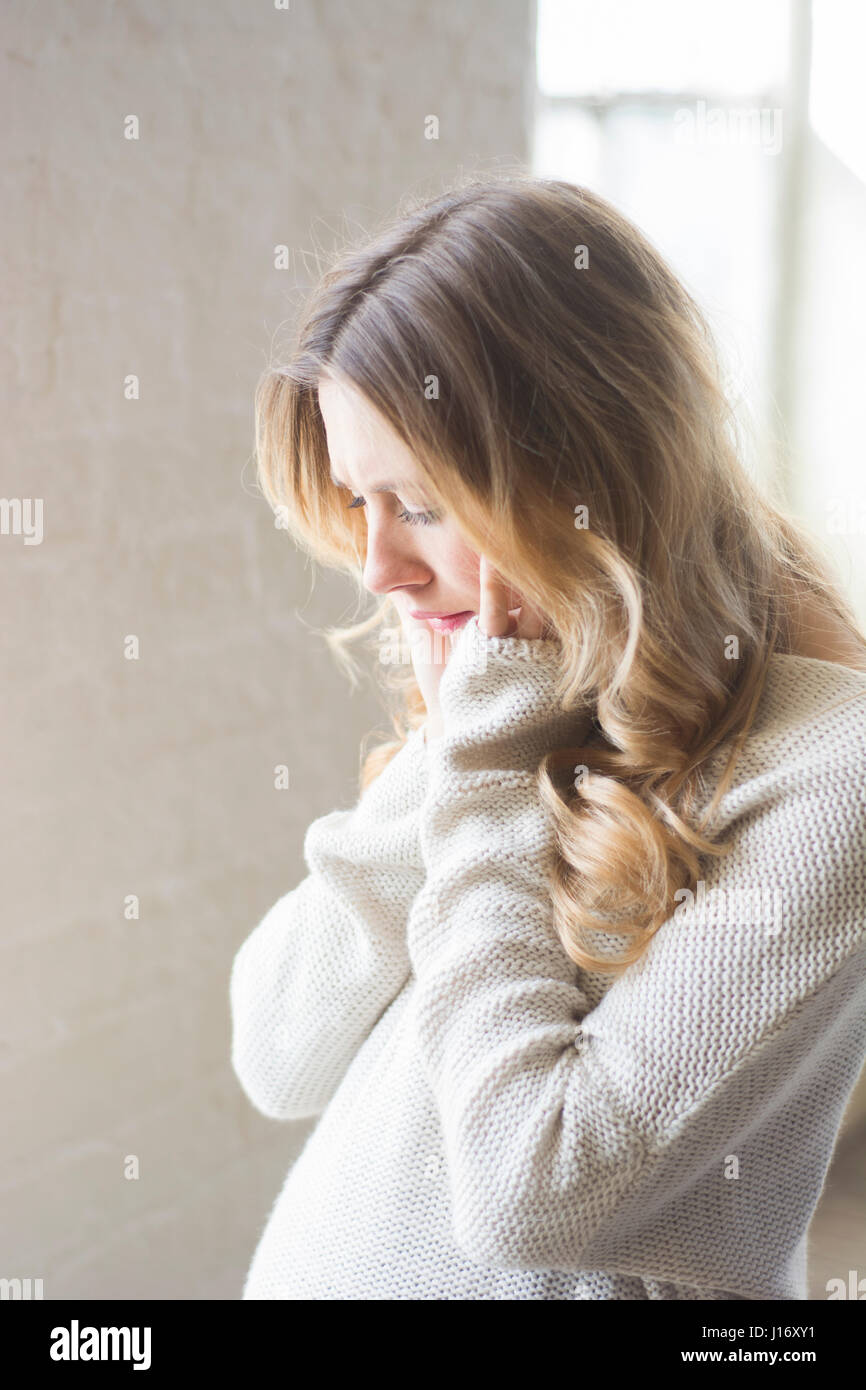 Side view of a stressed young woman hands touching face Stock Photo - Alamy