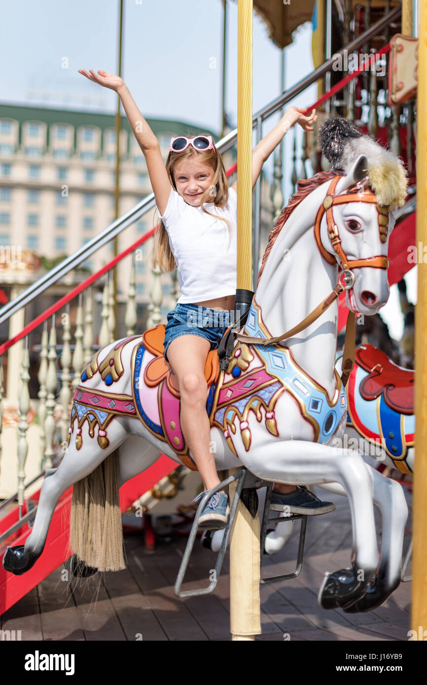 Girl riding on merry go round hi-res stock photography and images - Alamy