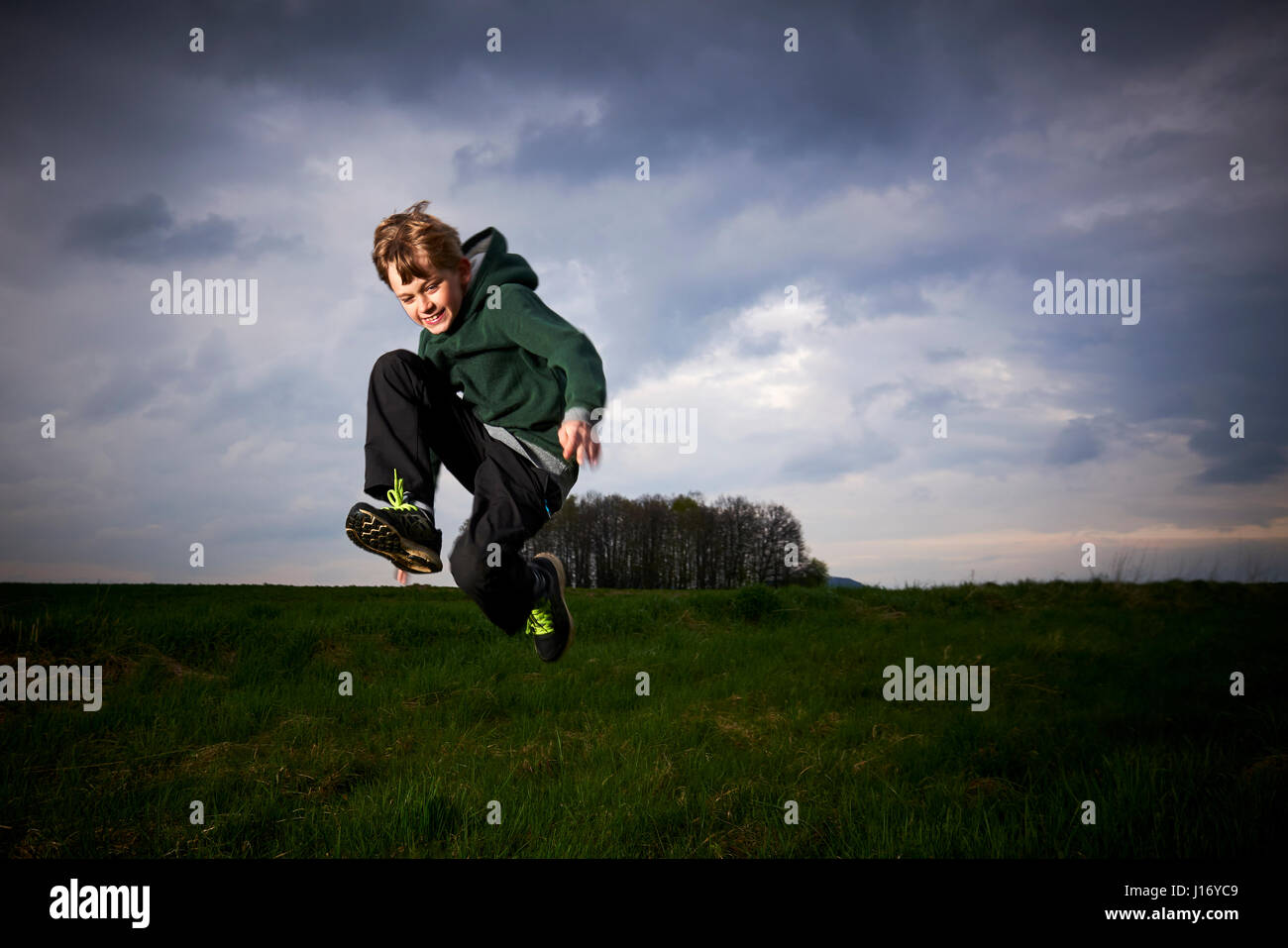 Child kid jumping outdoor grass jump hi-res stock photography and ...