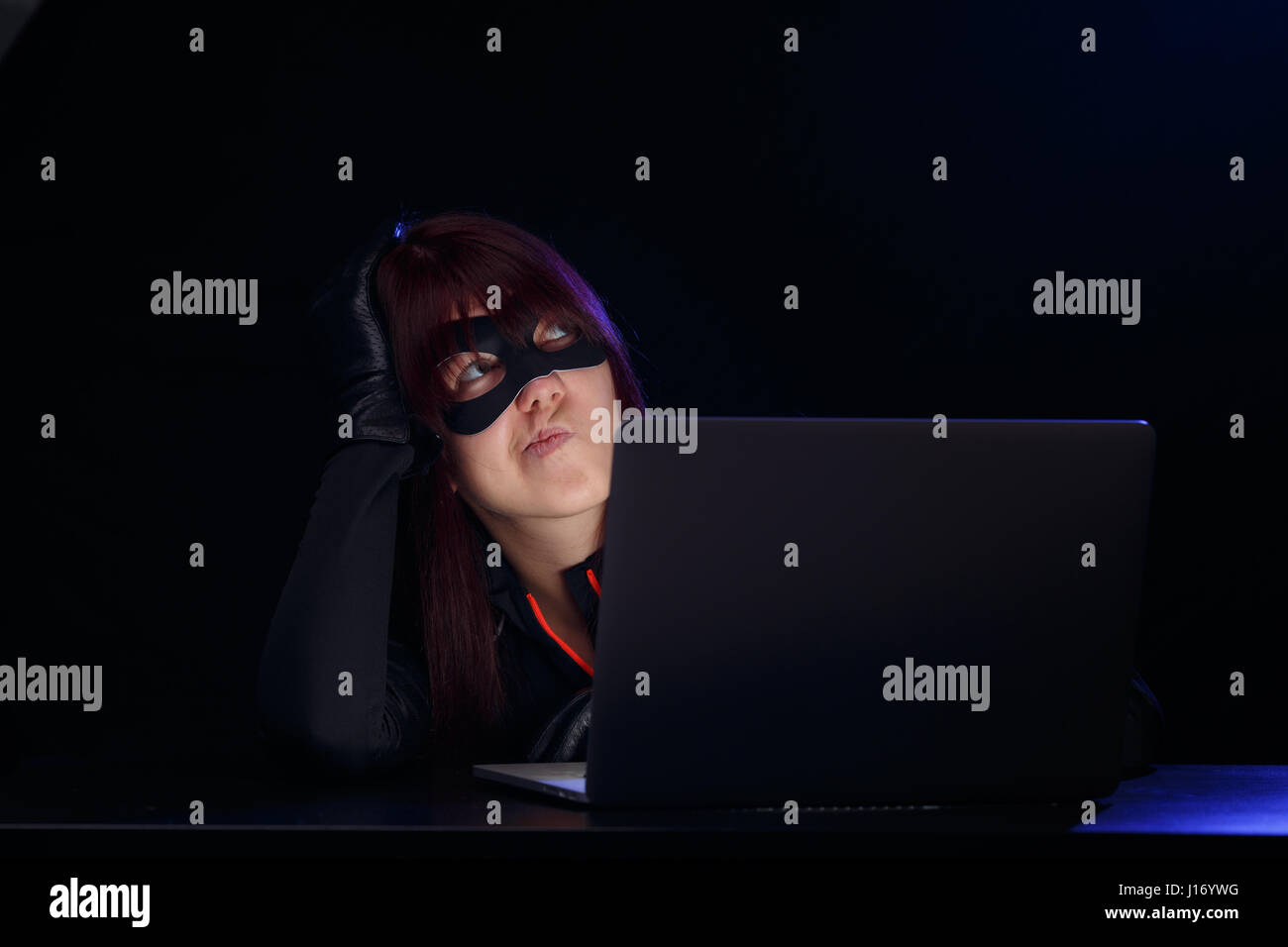 Young woman hacker with laptop Stock Photo - Alamy