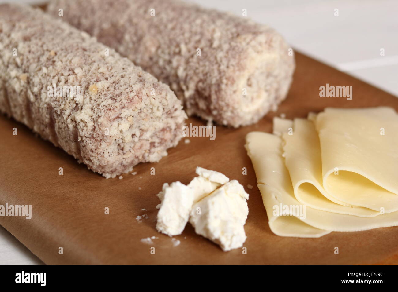 Uncooked meat roulade. Rolled meat with a filling of cheese and ham ...