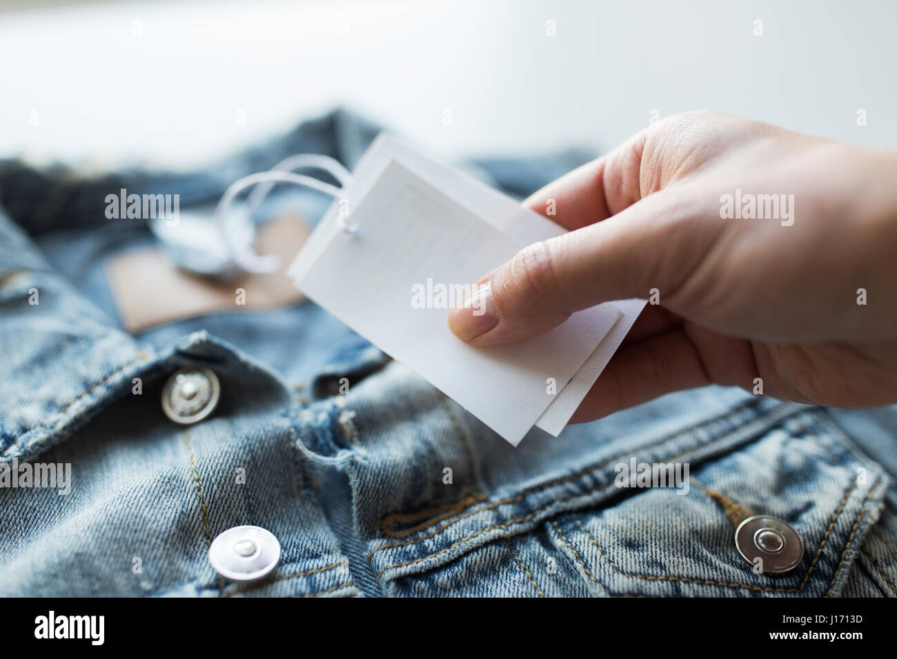 Hand holding by jacket hi-res stock photography and images - Alamy