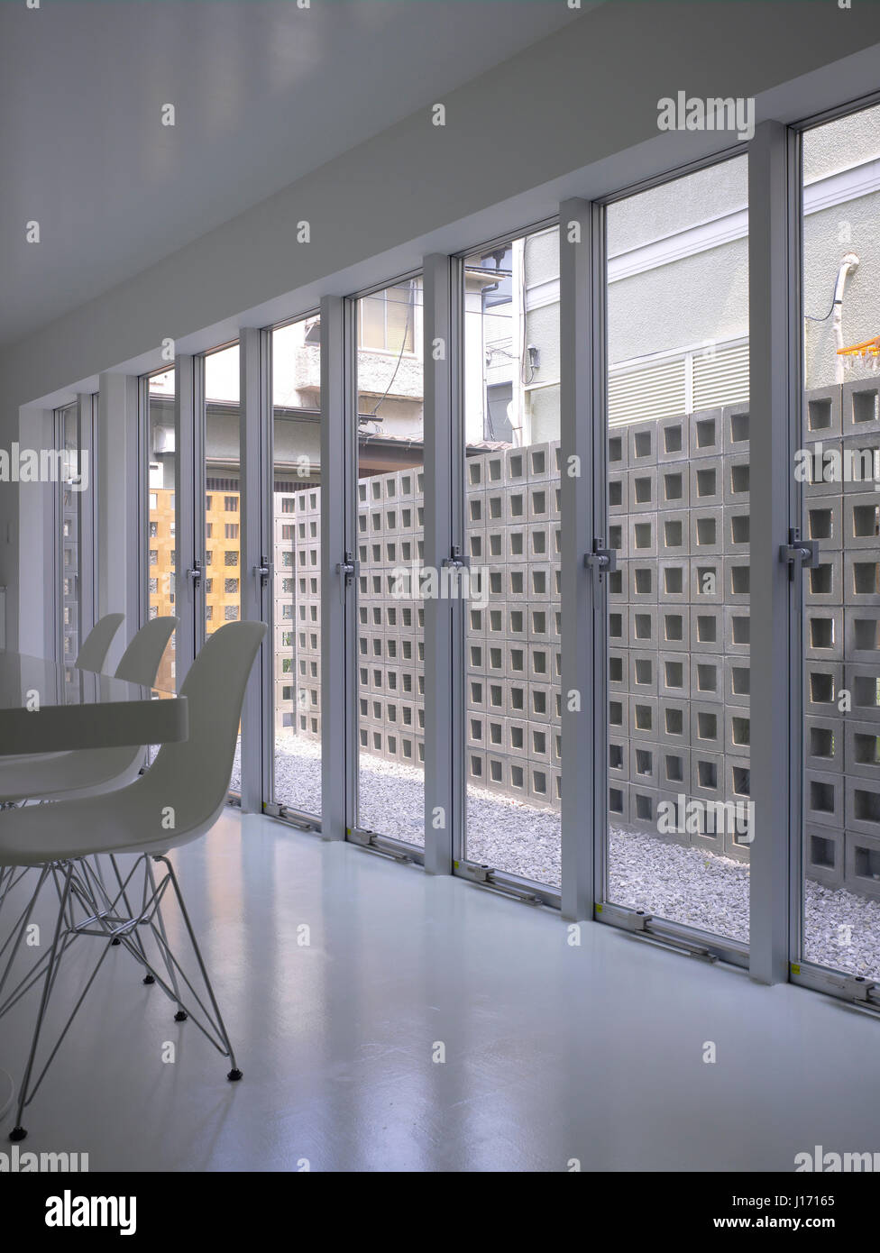 Dining area with with view towards perimeter wall. Townhouse in Tokyo ...