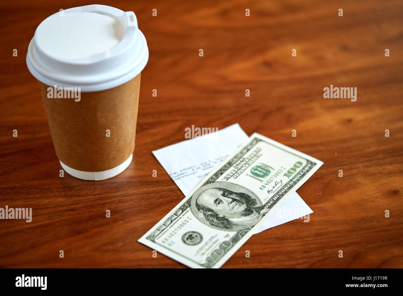 coffee in paper cup, bill and money on table Stock Photo - Alamy