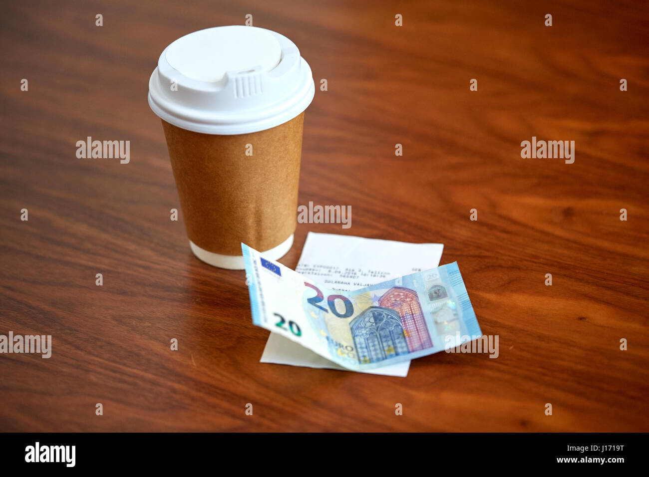 coffee in paper cup, bill and money on table Stock Photo - Alamy