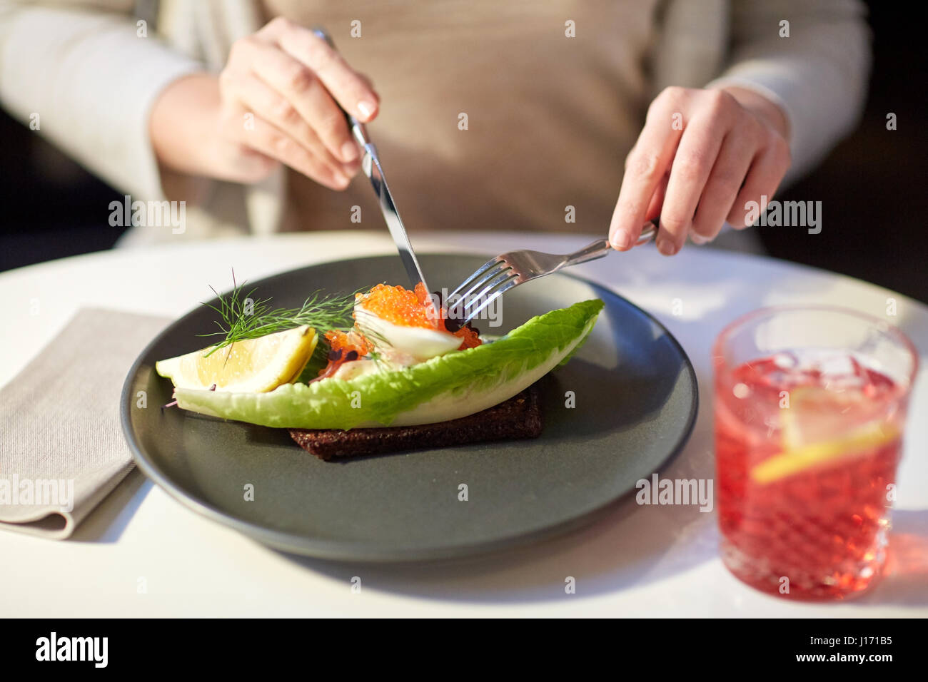woman eating caviar toast skagen at restaurant Stock Photo - Alamy