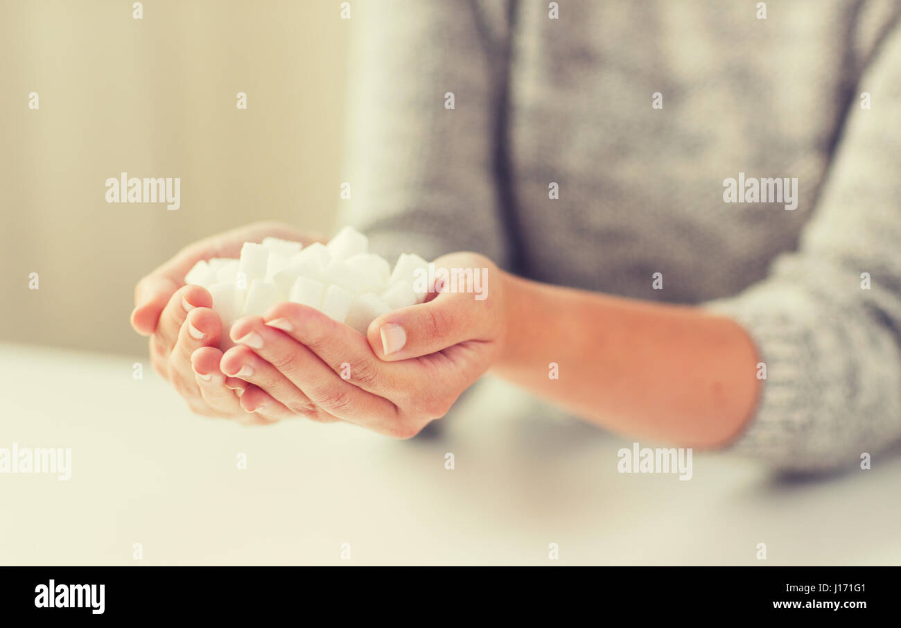 close up of white lump sugar in woman hands Stock Photo - Alamy